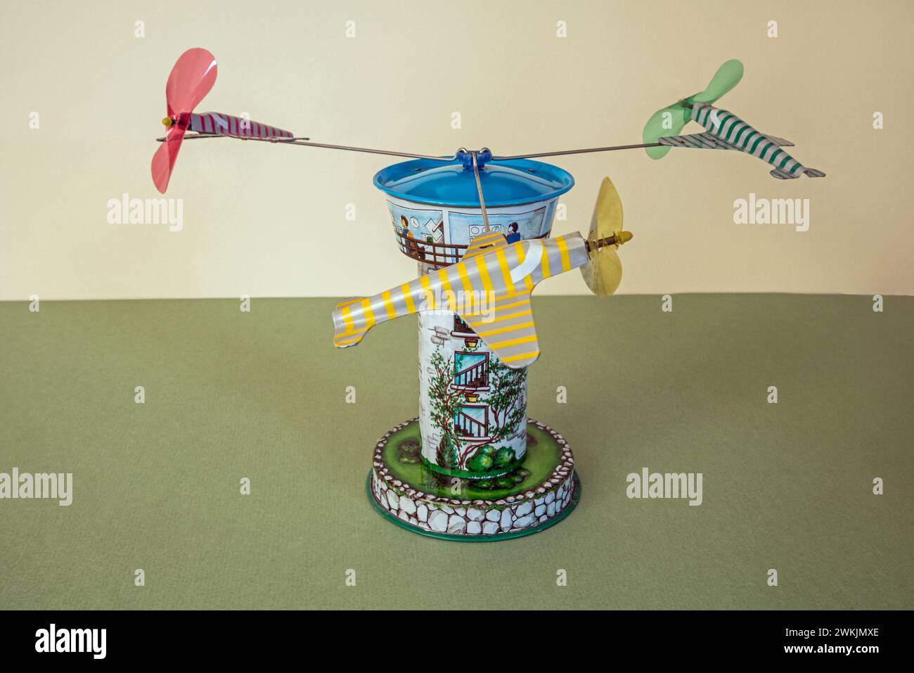 A clockwork tin plate air control tower with three aeroplanes ...