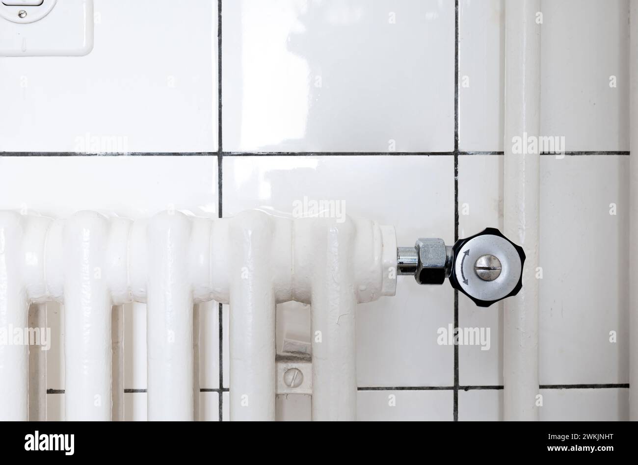 Cast iron home radiator thermostatic control valve. Front view, white ...