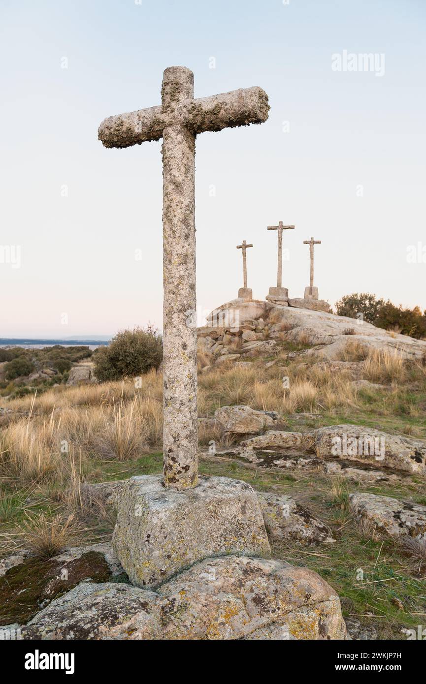 Three Crosses of carved stone on granite rock at dusk of Heaven Stock ...