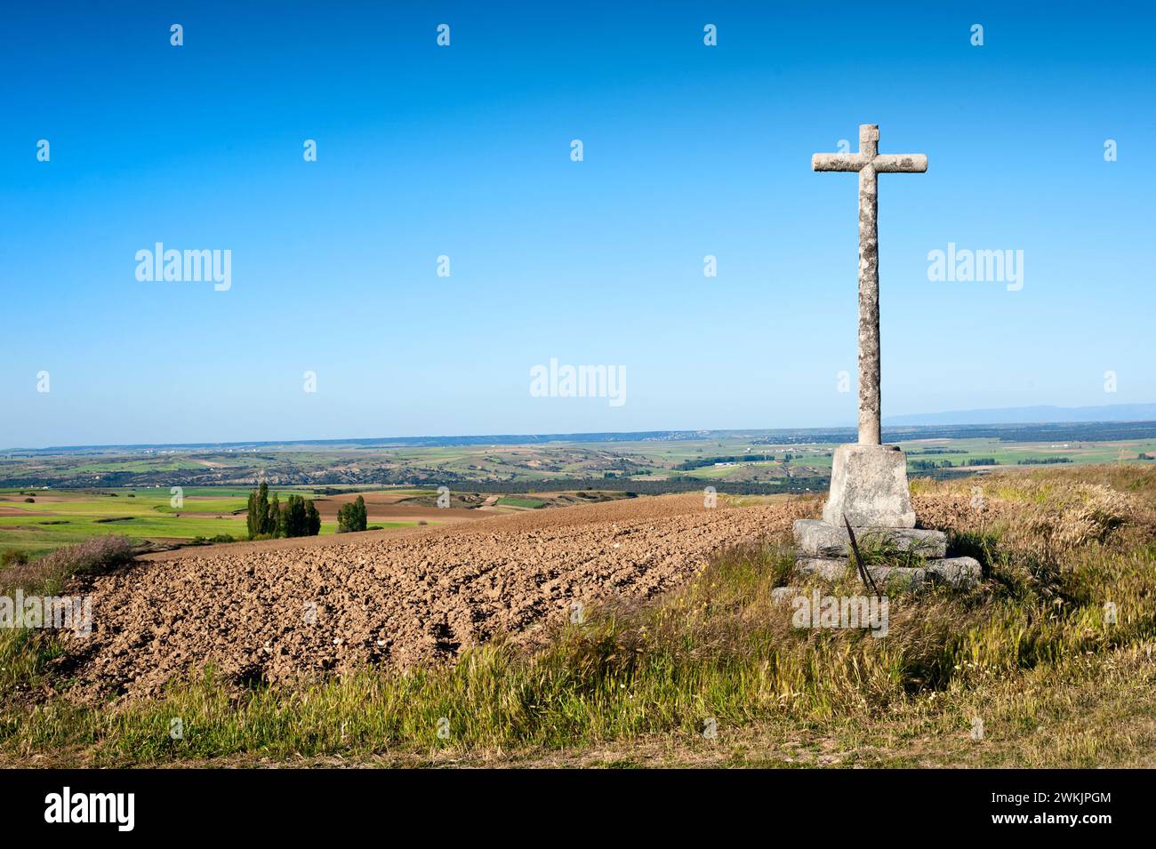 aged landscape with a cross in his right hand Stock Photo - Alamy
