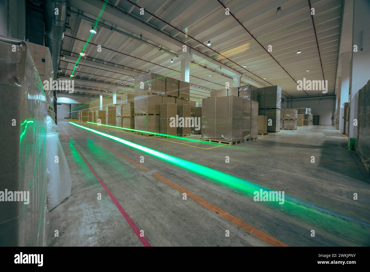 Light trails inside an automated warehouse where shipments are ...