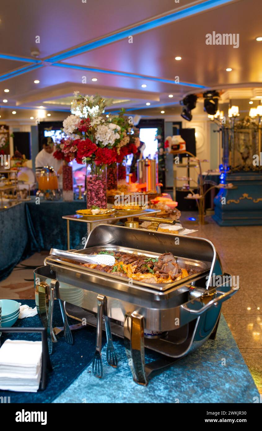 A buffet food warmer filled with delicious beef. The beef is cooked to ...