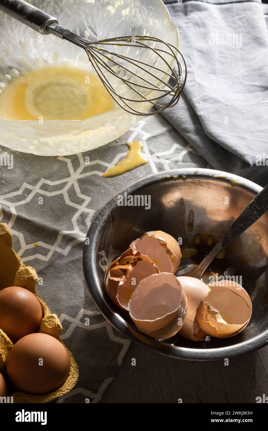 Cooking with eggs, cracked egg shells, used kitchen utensils on the ...