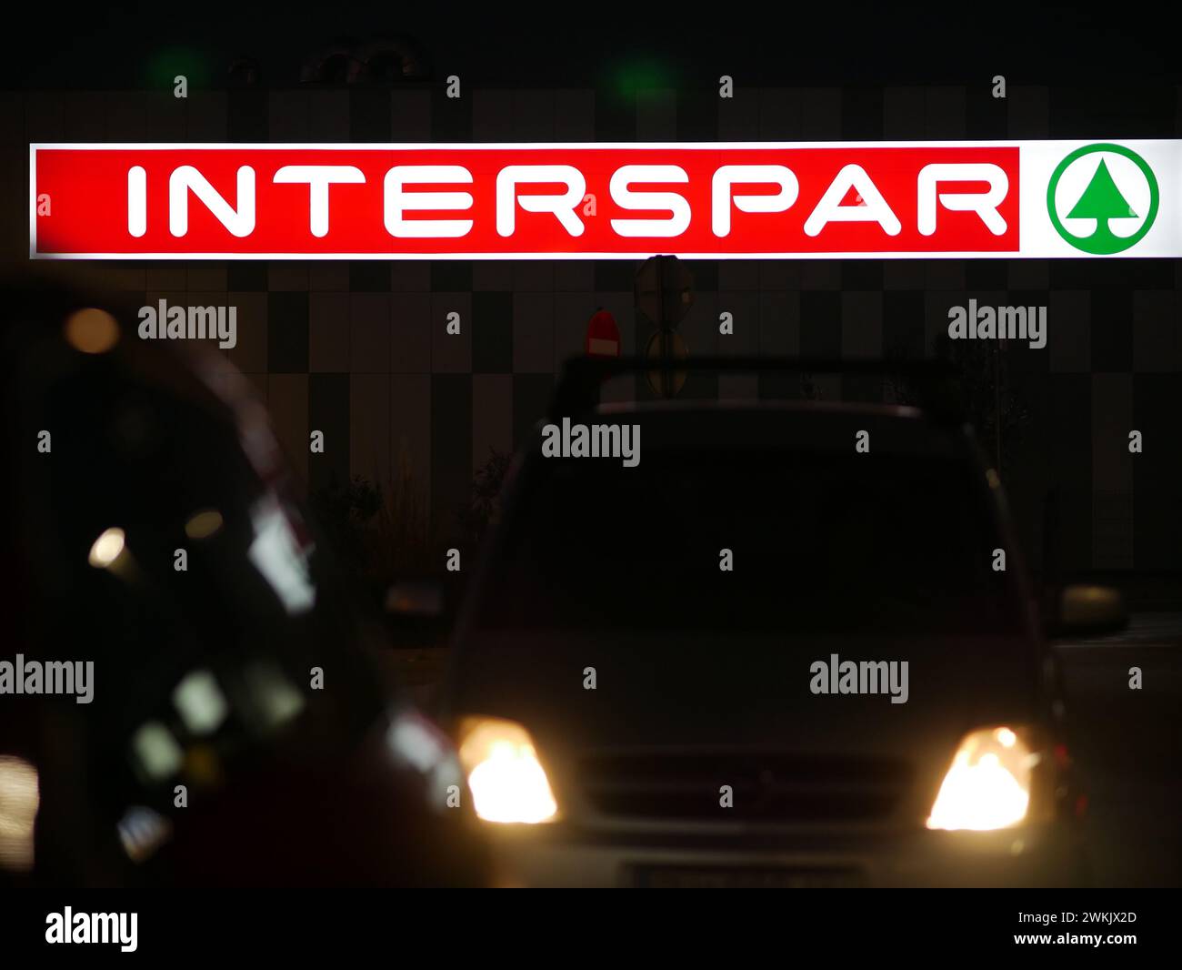 View of grocery store with glowing Interspar logo sign. Shopping ...