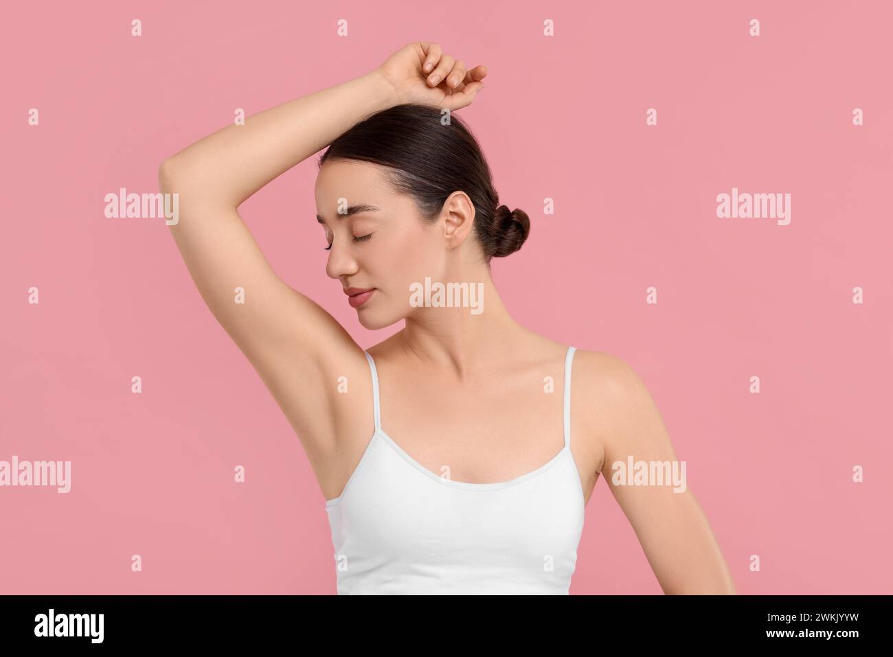 Beautiful woman showing armpit with smooth clean skin on pink ...
