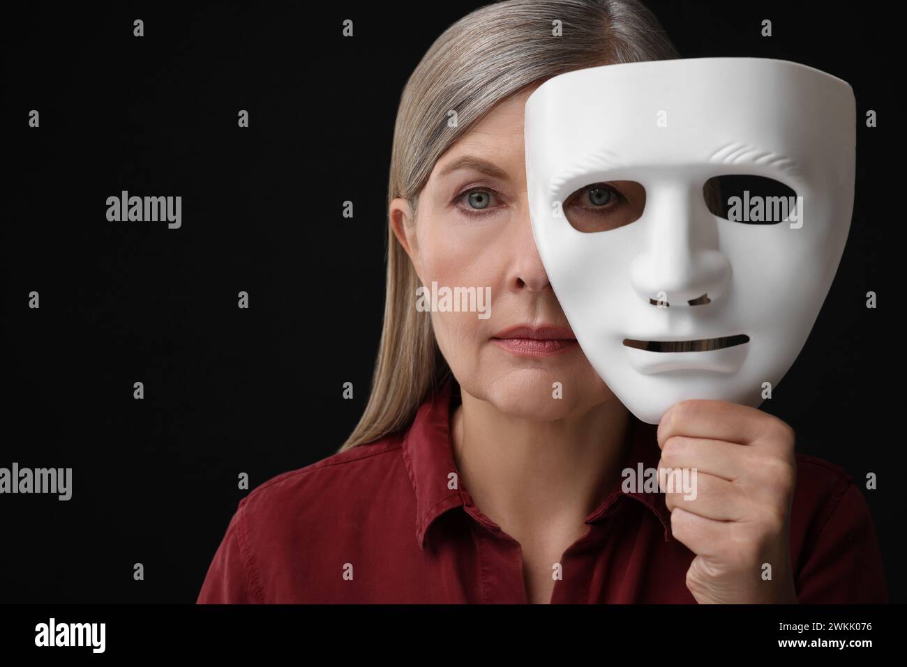 Multiple personality concept. Woman with mask on black background Stock ...