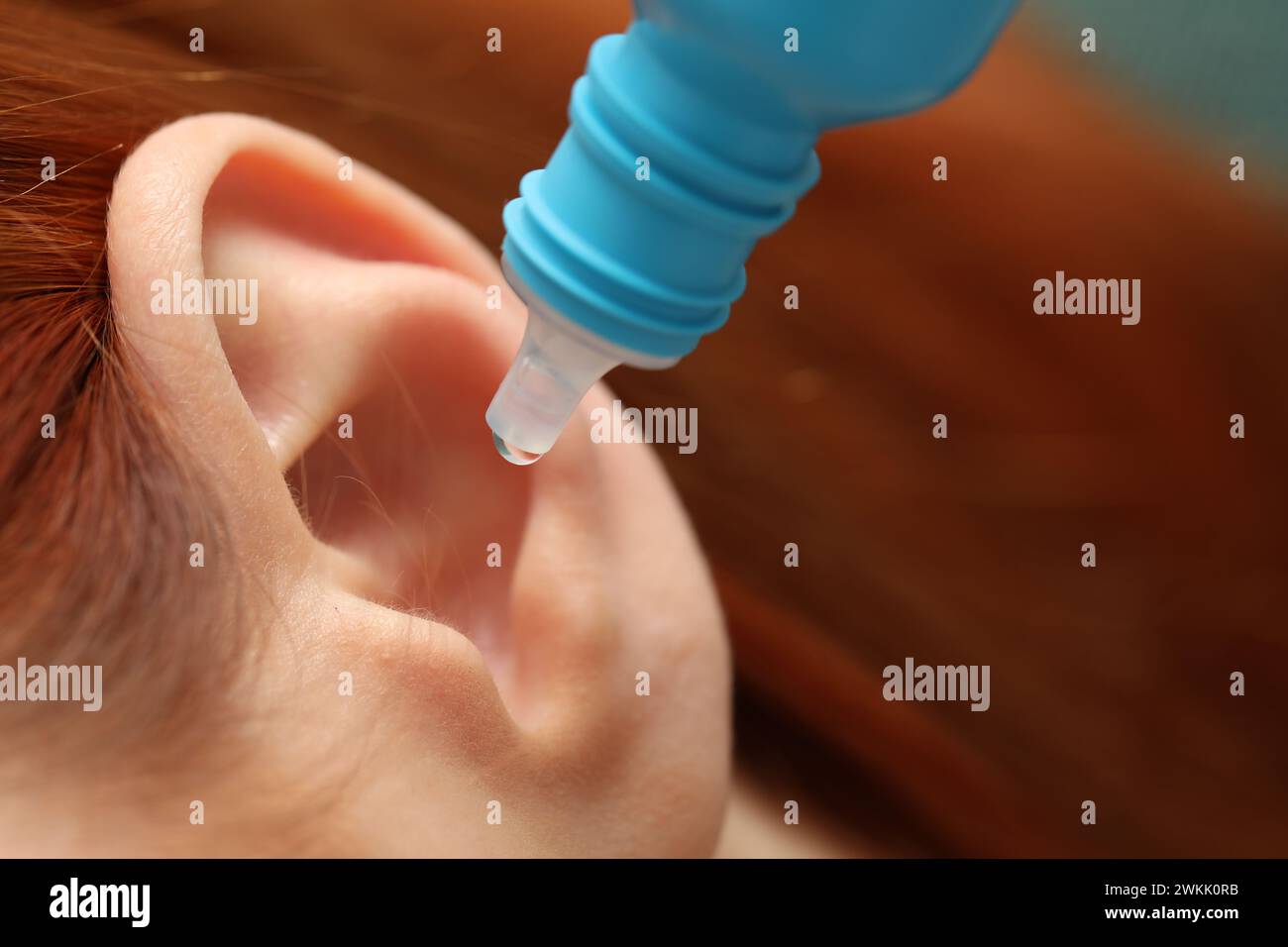 Woman applying medical ear drops, macro view Stock Photo - Alamy