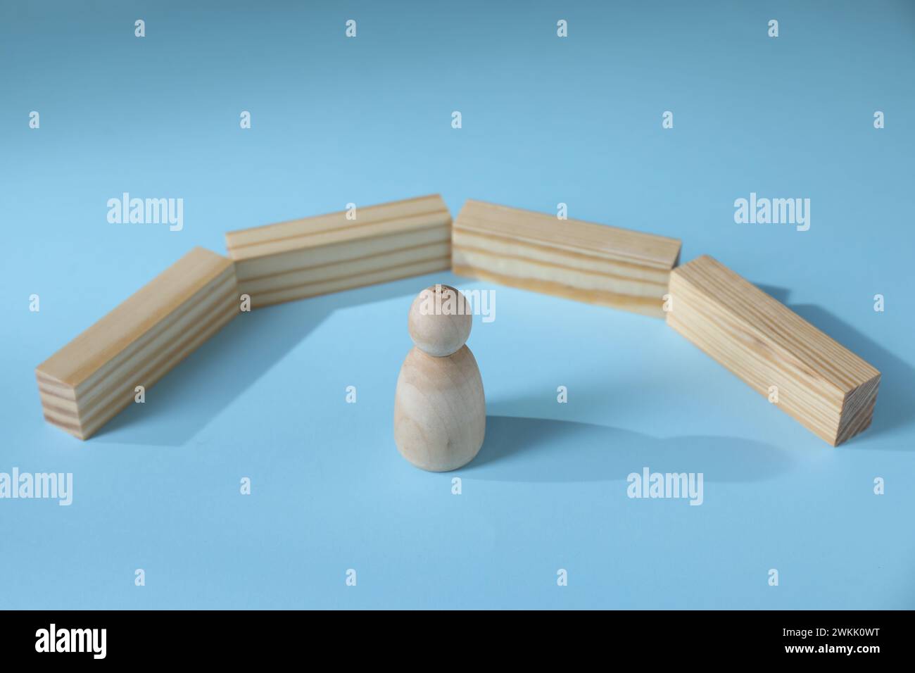 Overcoming barries for development and success. Wooden human figure ...