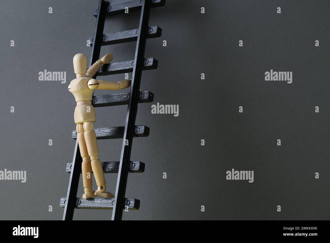 Overcoming barries for development and success. Wooden human figure ...