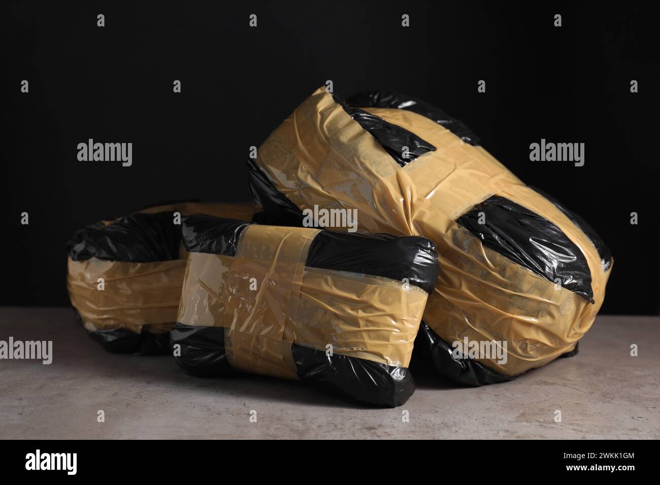 Smuggling and drug trafficking. Packages with narcotics on grey table ...