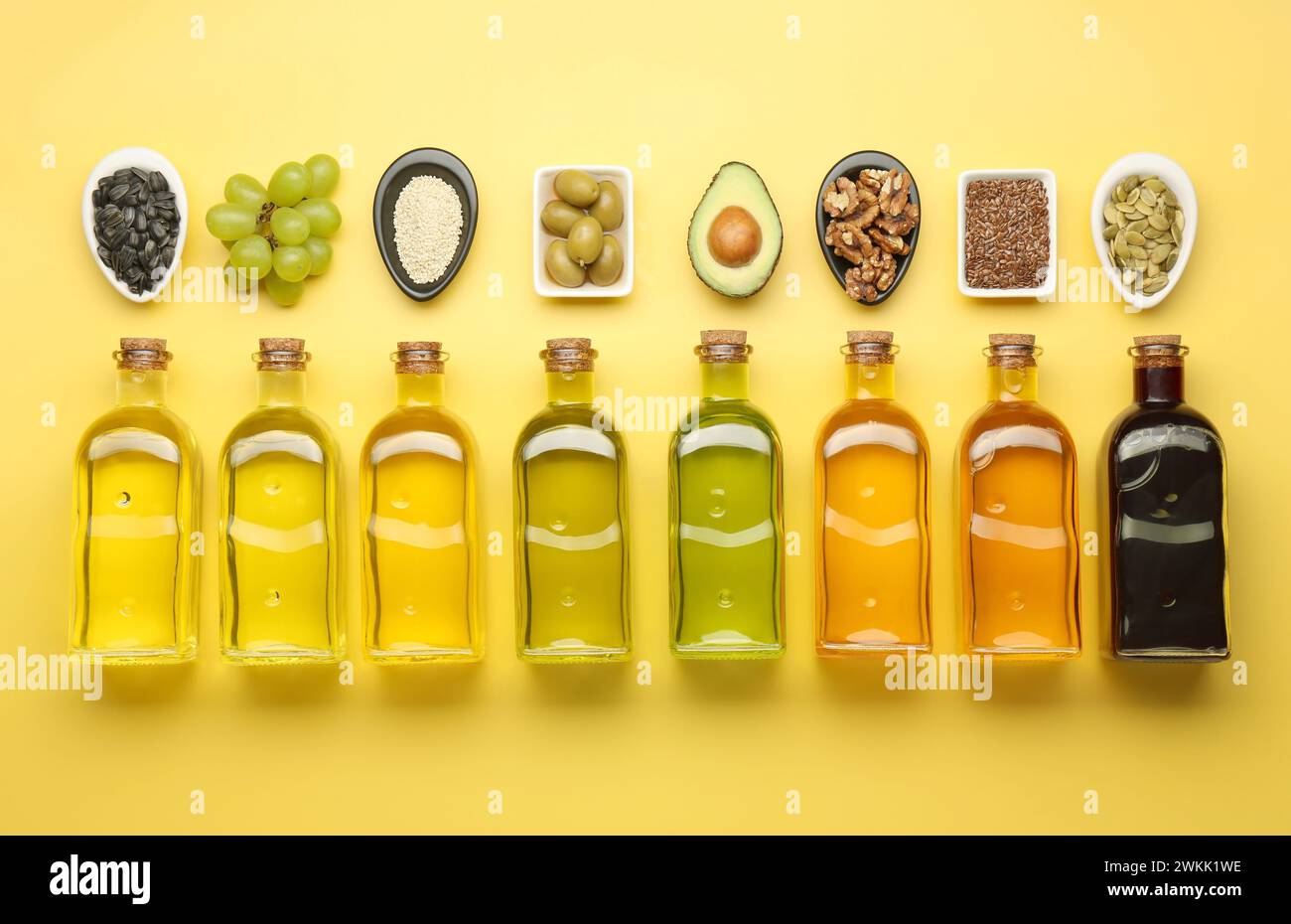 Vegetable fats. Different oils in glass bottles and ingredients on ...