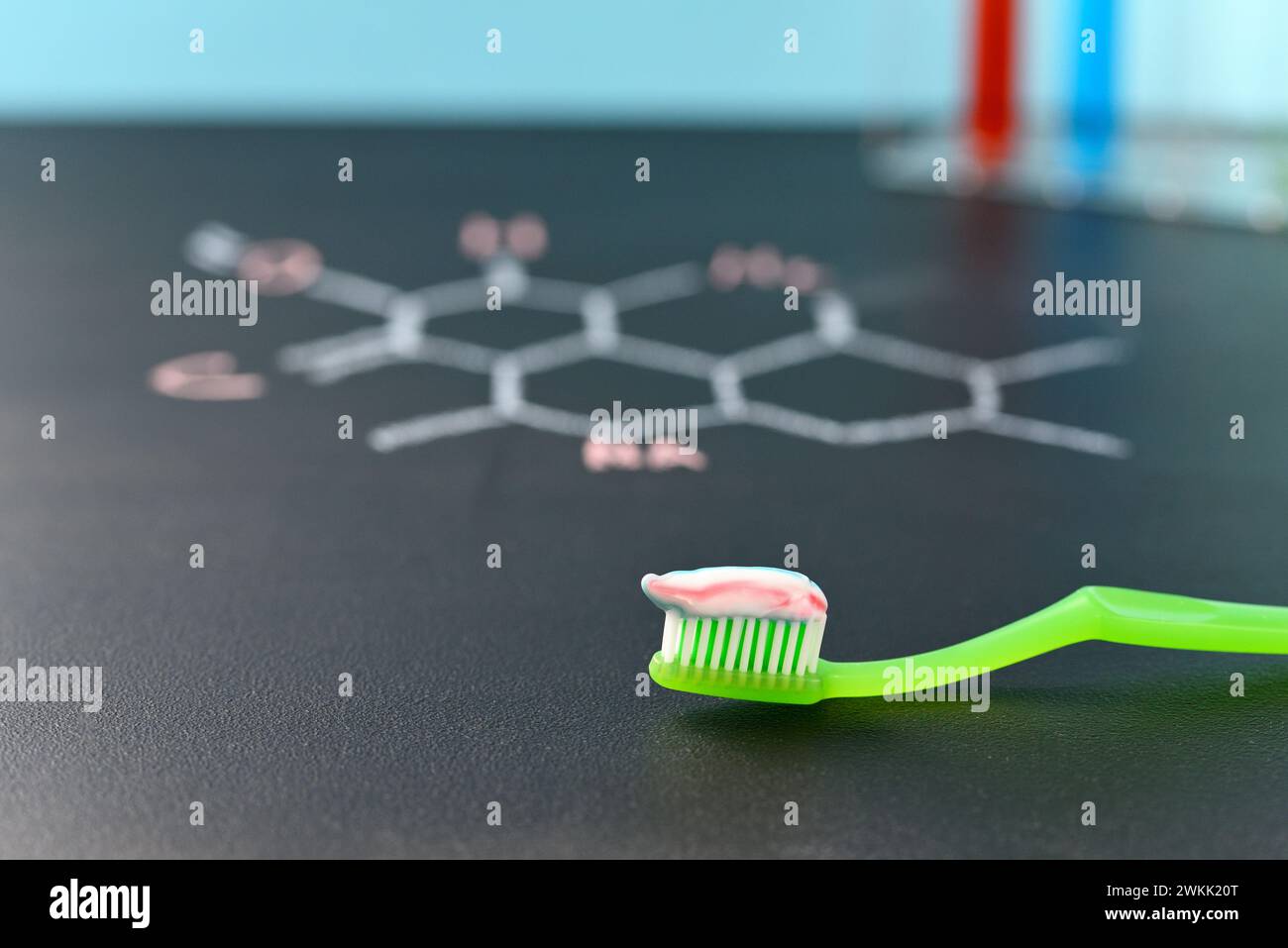 Toothpaste applied to the toothbrush on a background of the chemical ...