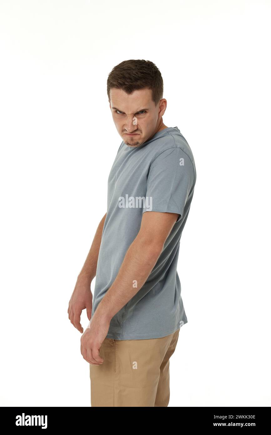 annoyed angry man standing on white studio background Stock Photo - Alamy