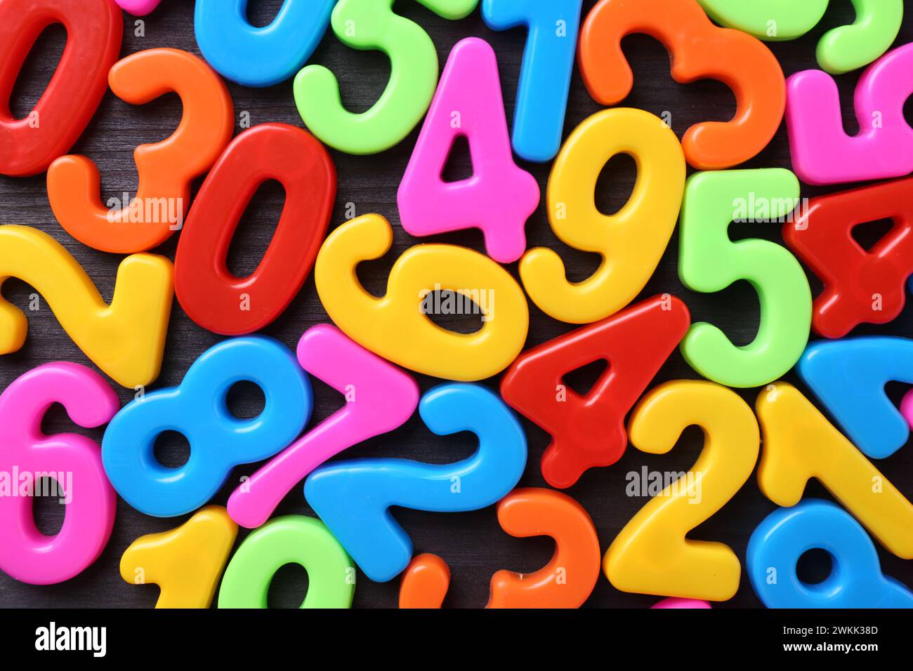 Colorful numbers on dark wooden school desk, top view Stock Photo - Alamy