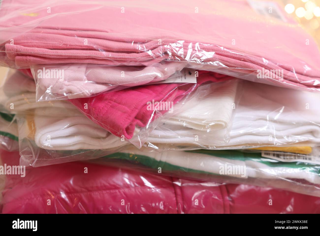 Stack of folded clothes in plastic bags, closeup Stock Photo - Alamy