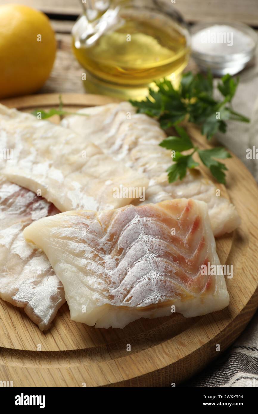 Fresh raw cod fillets on wooden table, closeup Stock Photo - Alamy