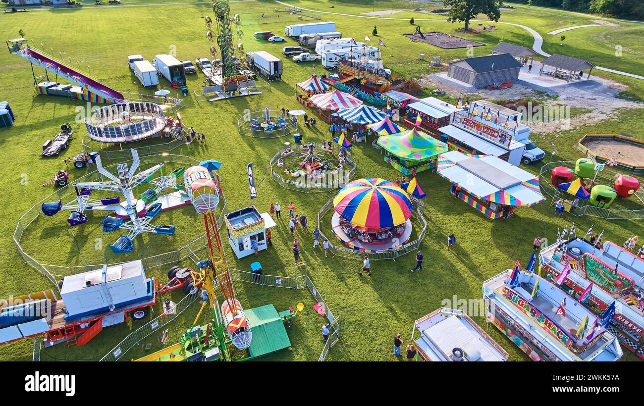 Aerial View of Bustling Carnival with Ferris Wheel and Rides at Golden ...