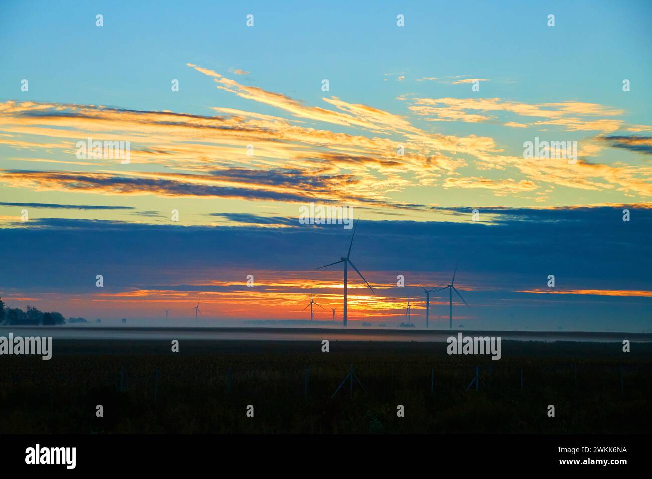 Renewable Energy Dawn with Wind Turbines and Misty Fields Stock Photo ...
