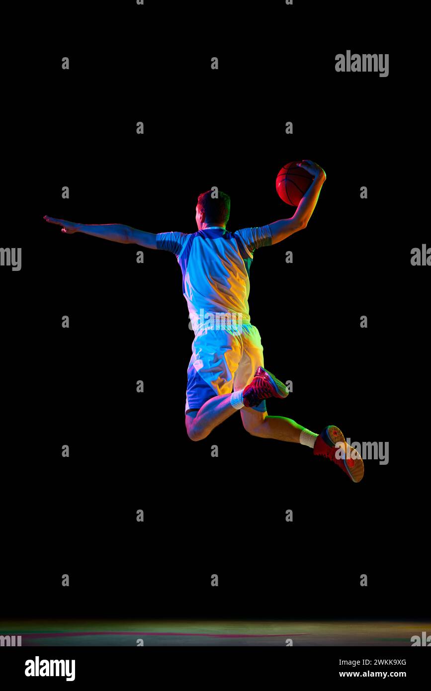 Dynamic portrait of basketball player doing perfect layup in action ...