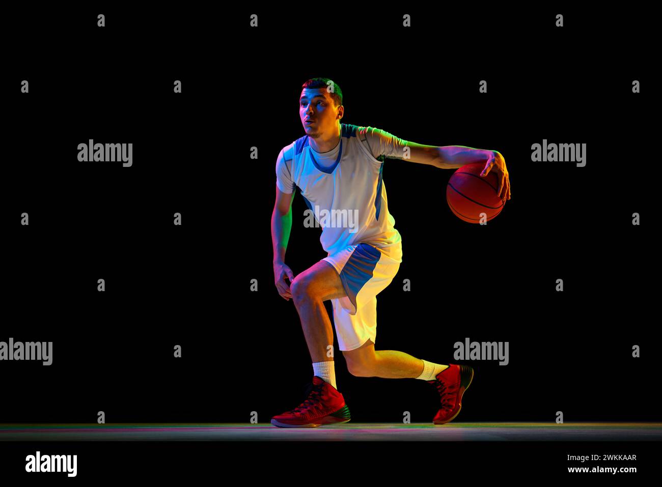 Skilled, focused basketball player performs combined ball-handling ...