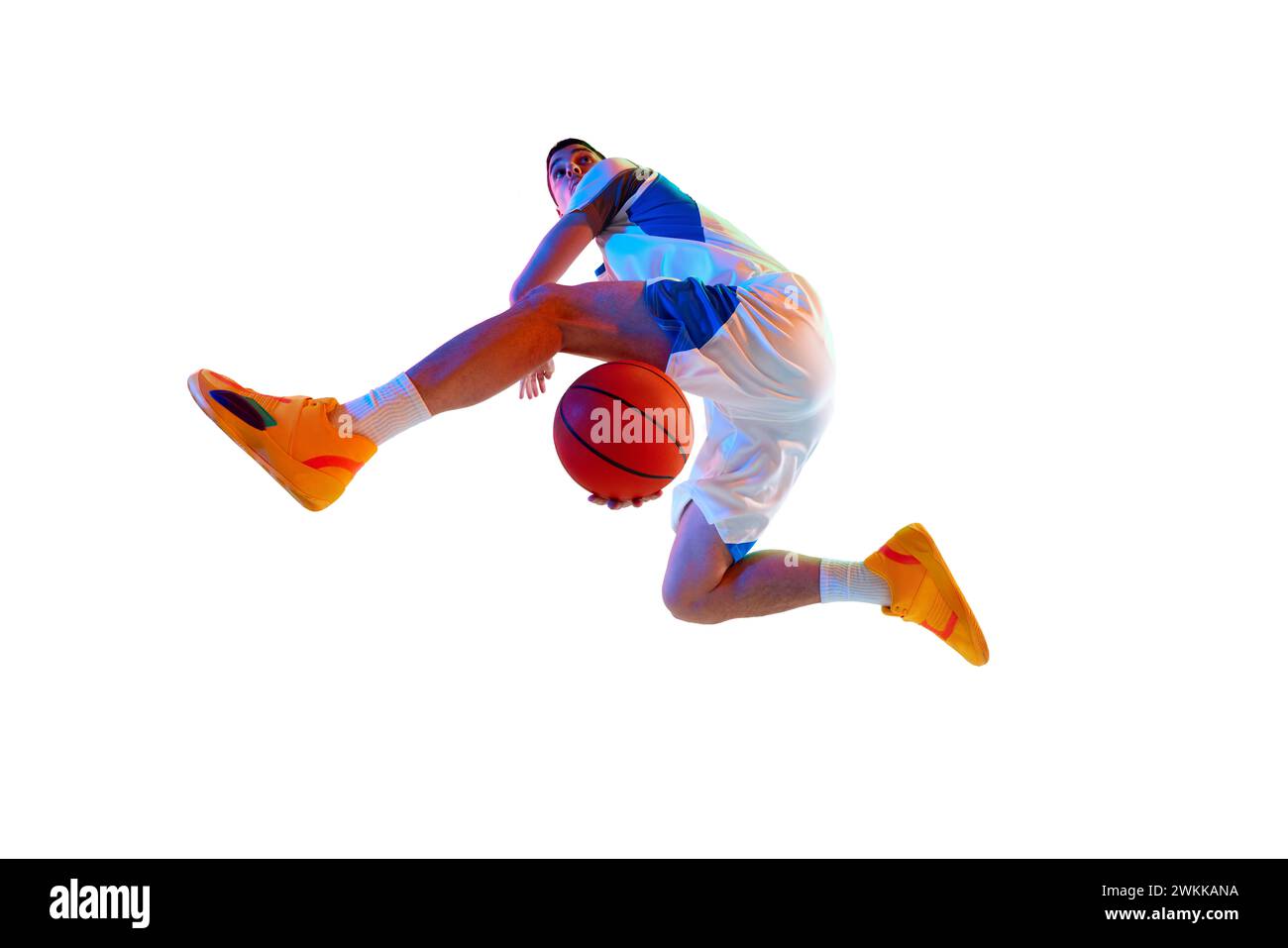 Low angle view. High-flying basketball player performing dunk in motion ...