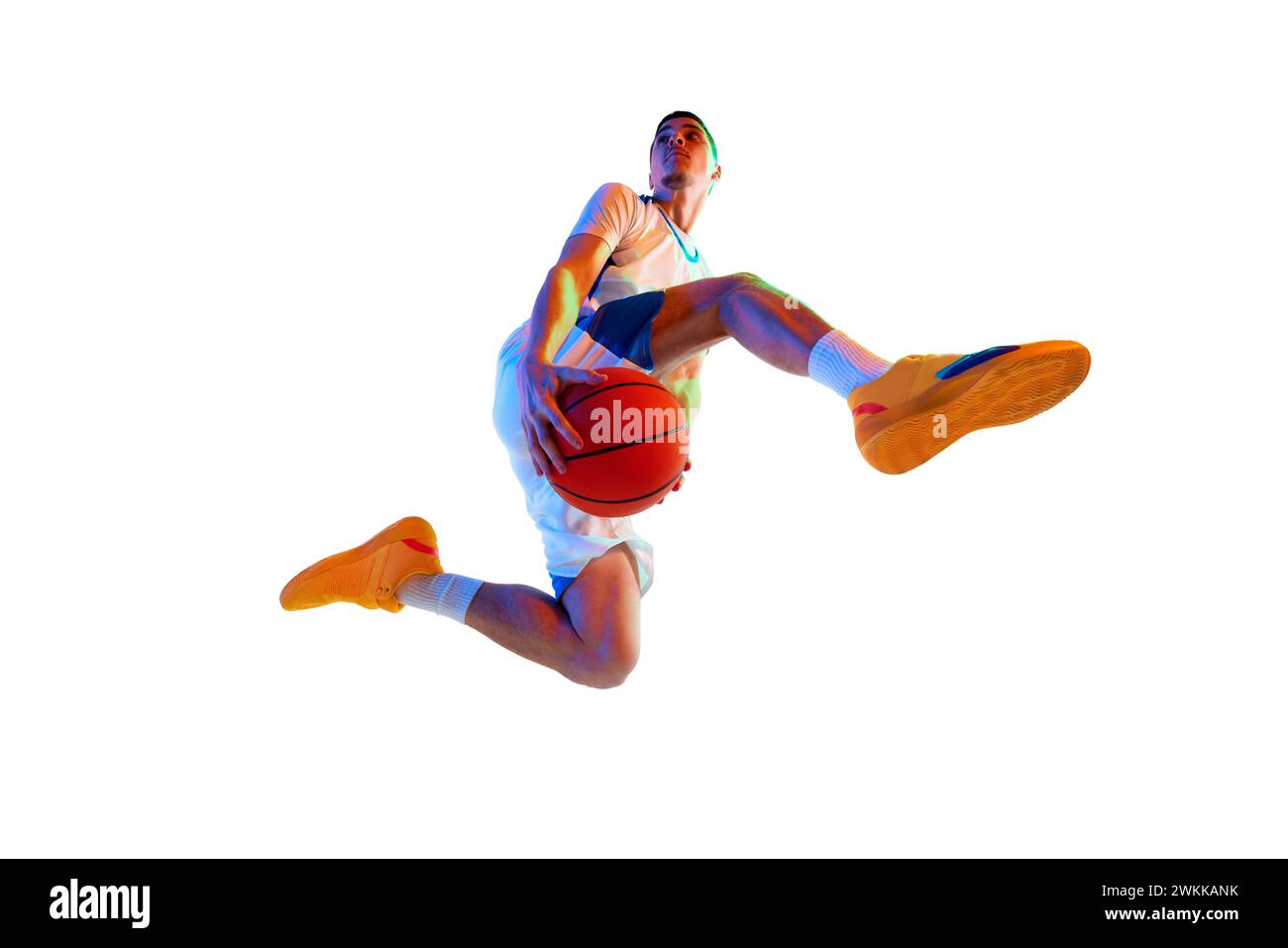 Low angle view. Athletic man in mid-jump shot with basketball ball ...