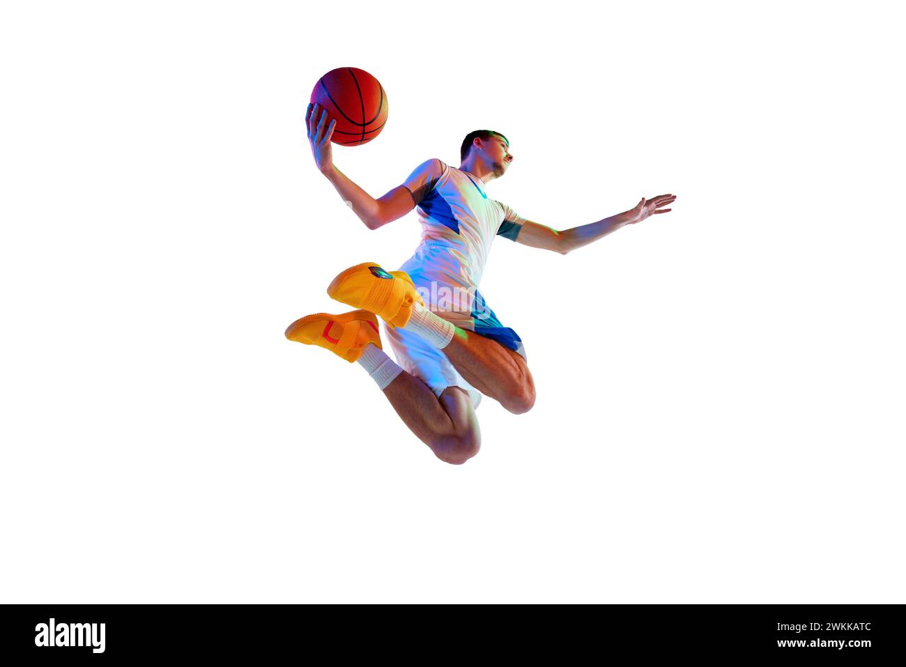 Basketball player in high-flying makes powerful dunk in motion against ...