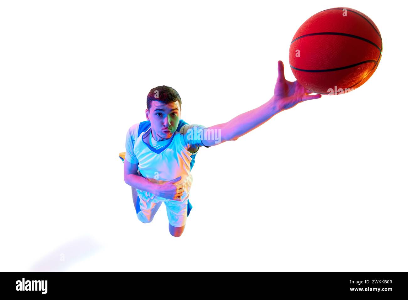 Overhead view of basketball player reaching out for slam dunk with ...