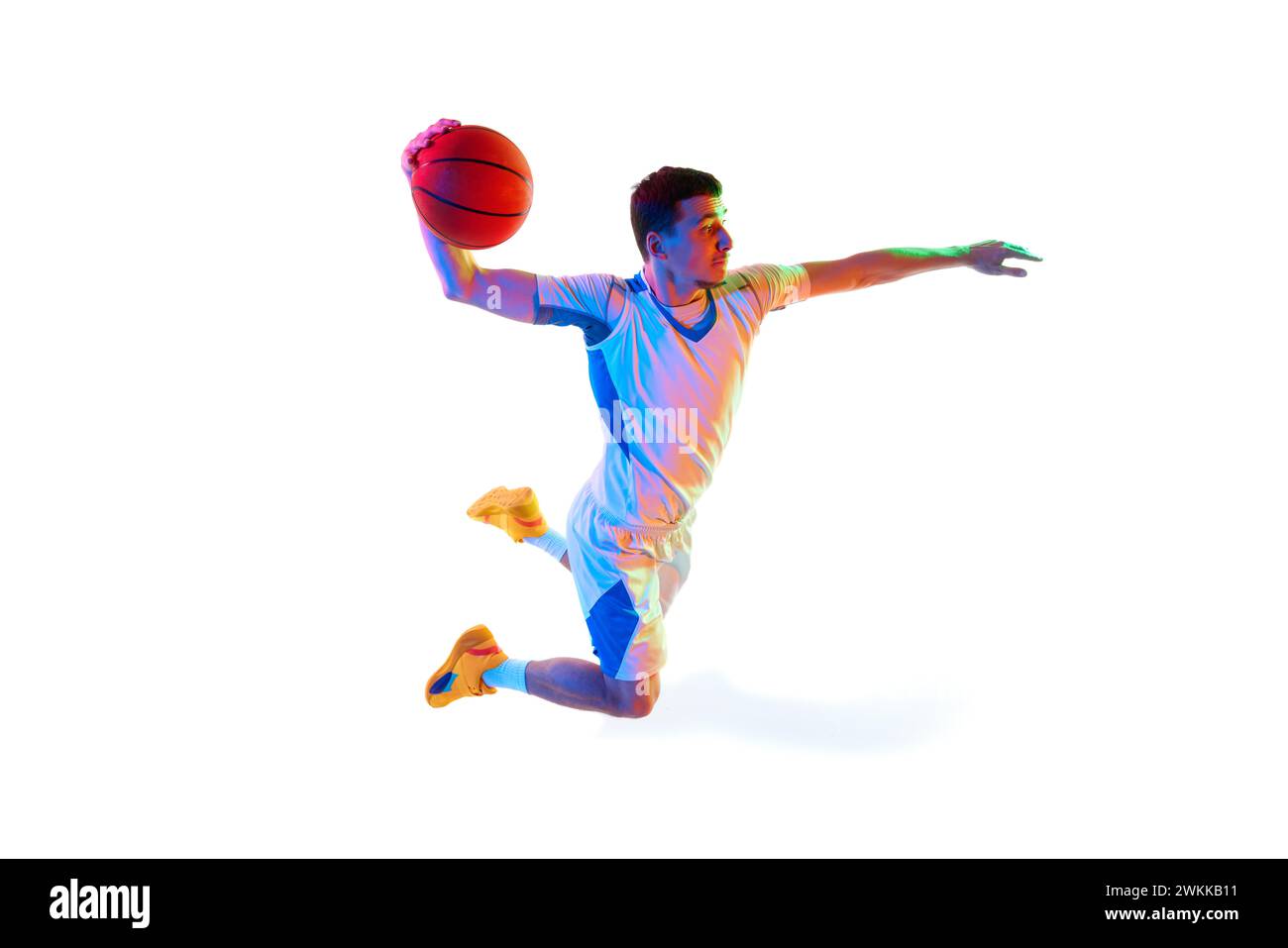 Focused basketball player in game progress doing powerful dunk in ...