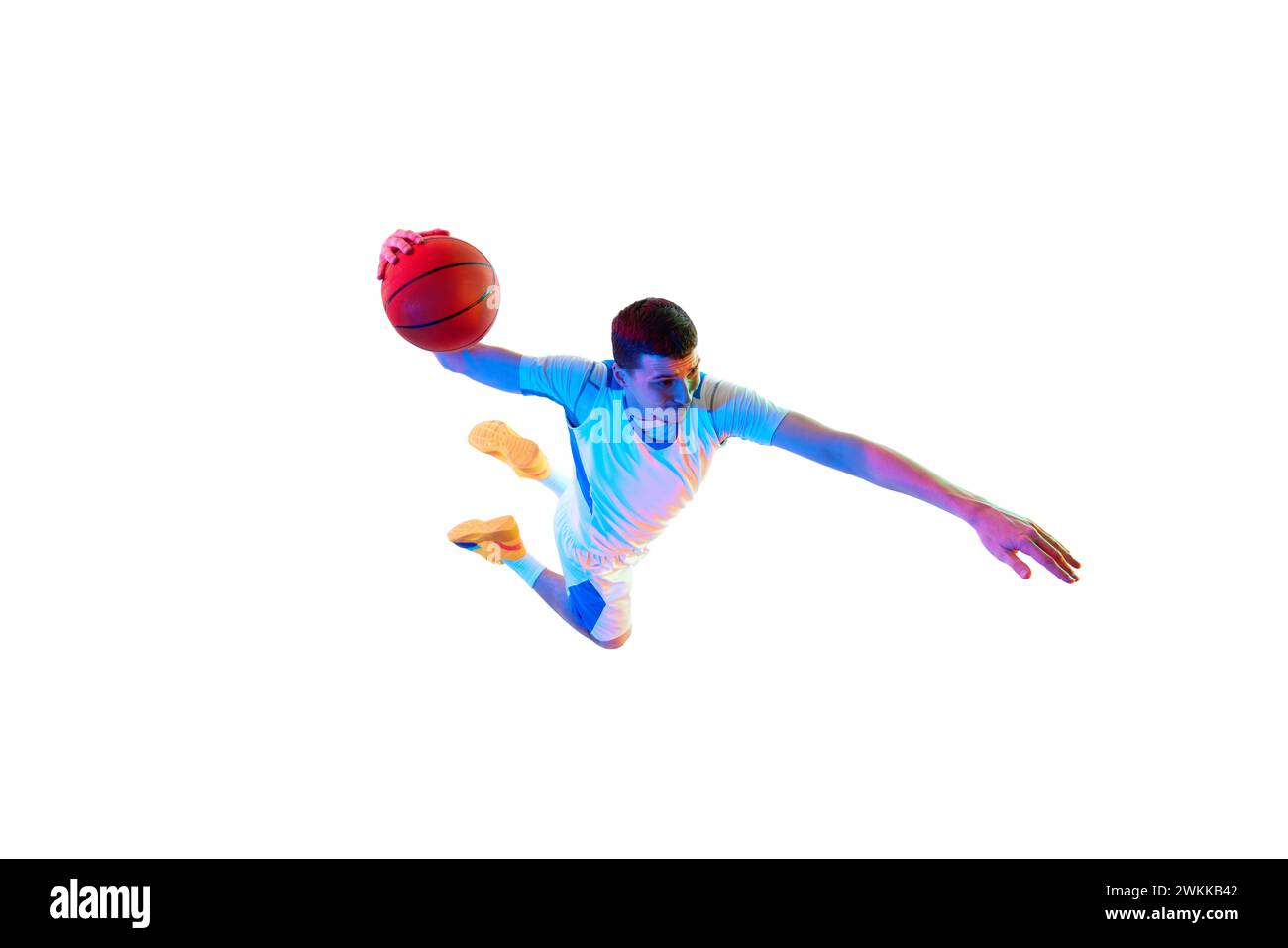 Action shot from above of player performing powerful basketball dunk ...