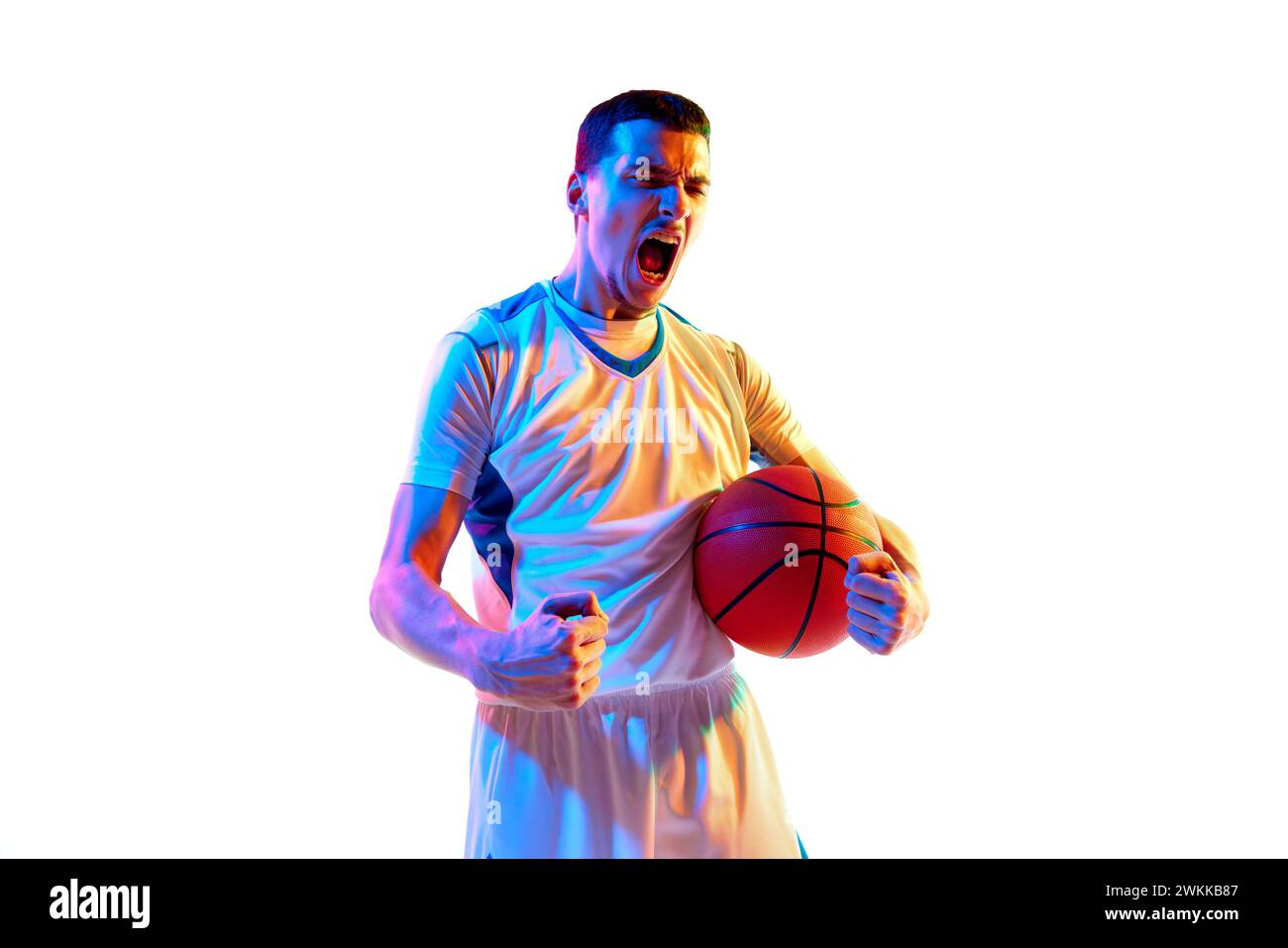 Emotional sportsman, basketball player shouting holding ball and ...