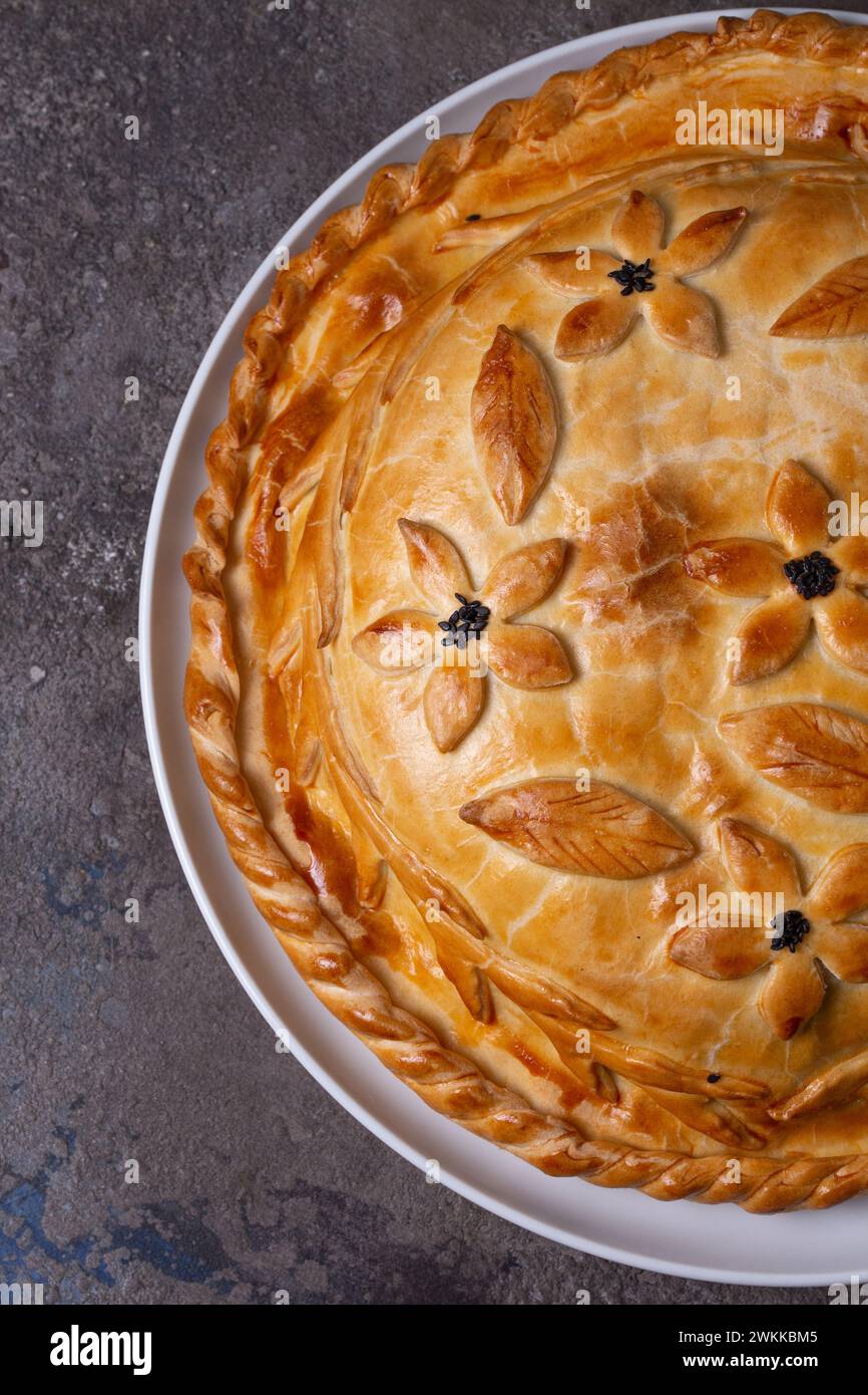 Golden brown top crust with decorative flourishes over savory meat ...