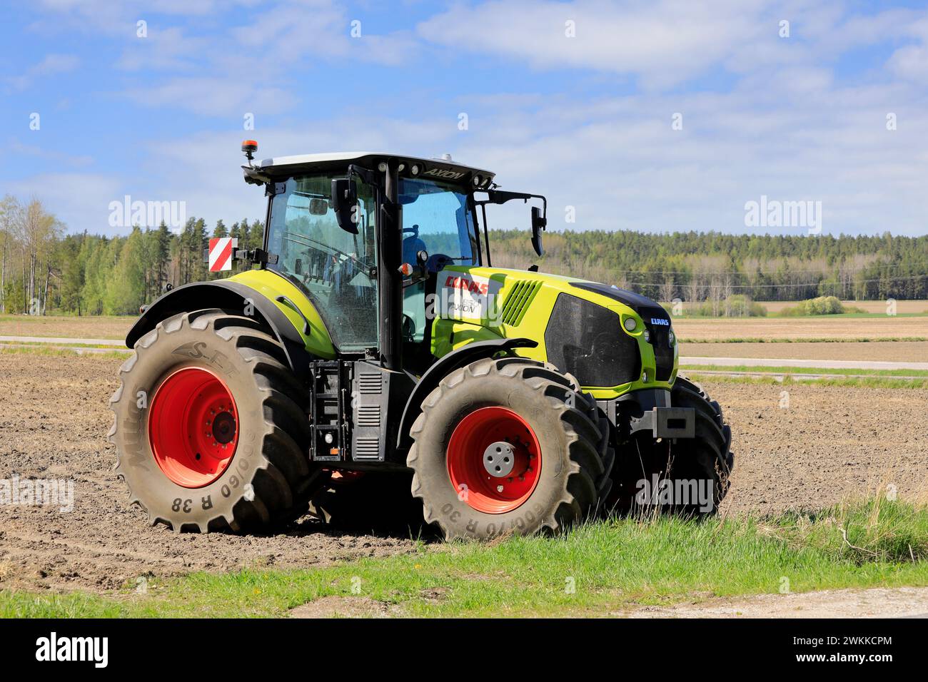 Claas Axion 850 tractor in field on a sunny day of spring. Salo ...