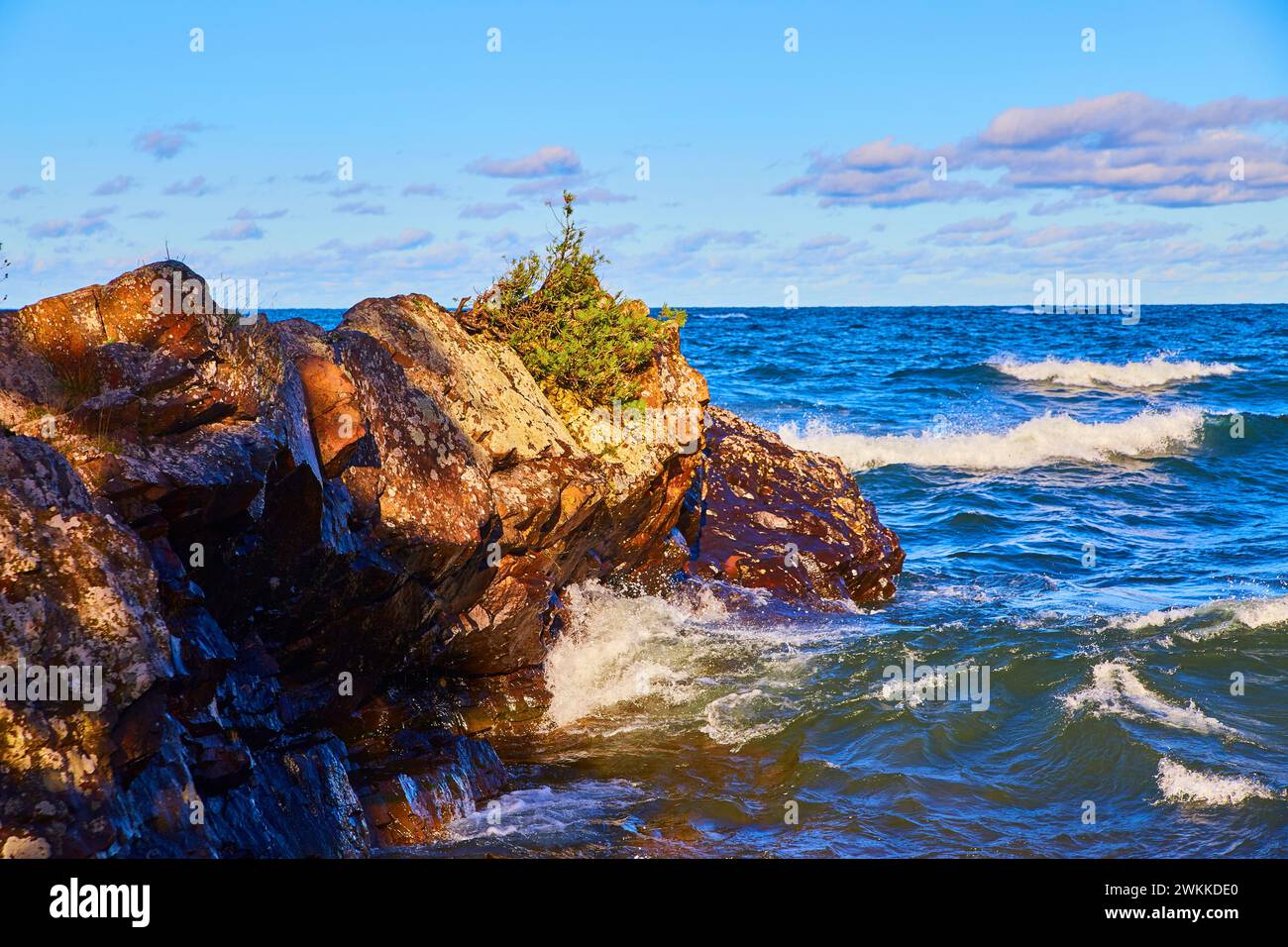 Rugged Coastal Rocks and Waves at Eagle Harbor Lighthouse Stock Photo ...