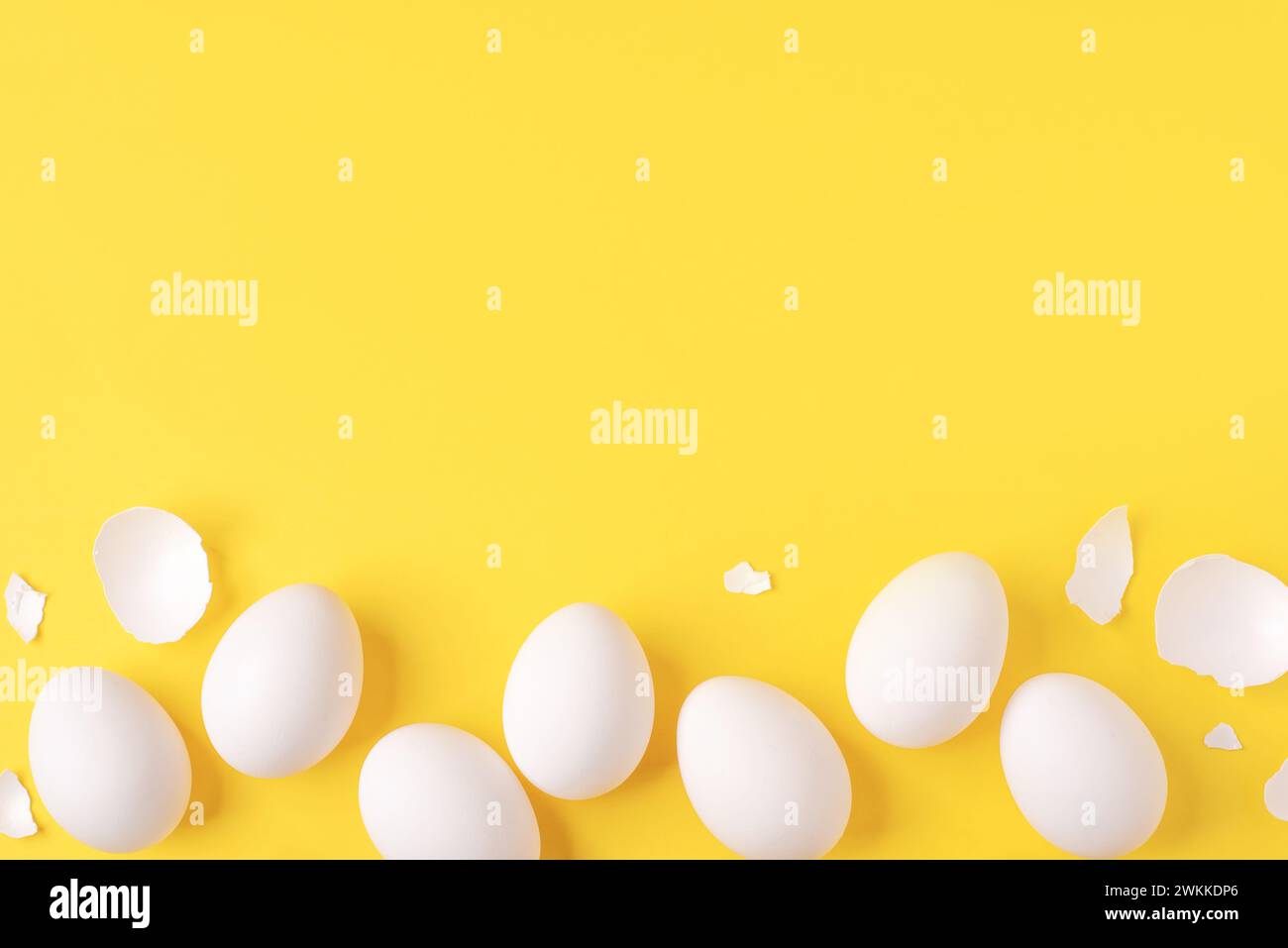 White Easter eggs and shells on a bright yellow background Stock Photo ...