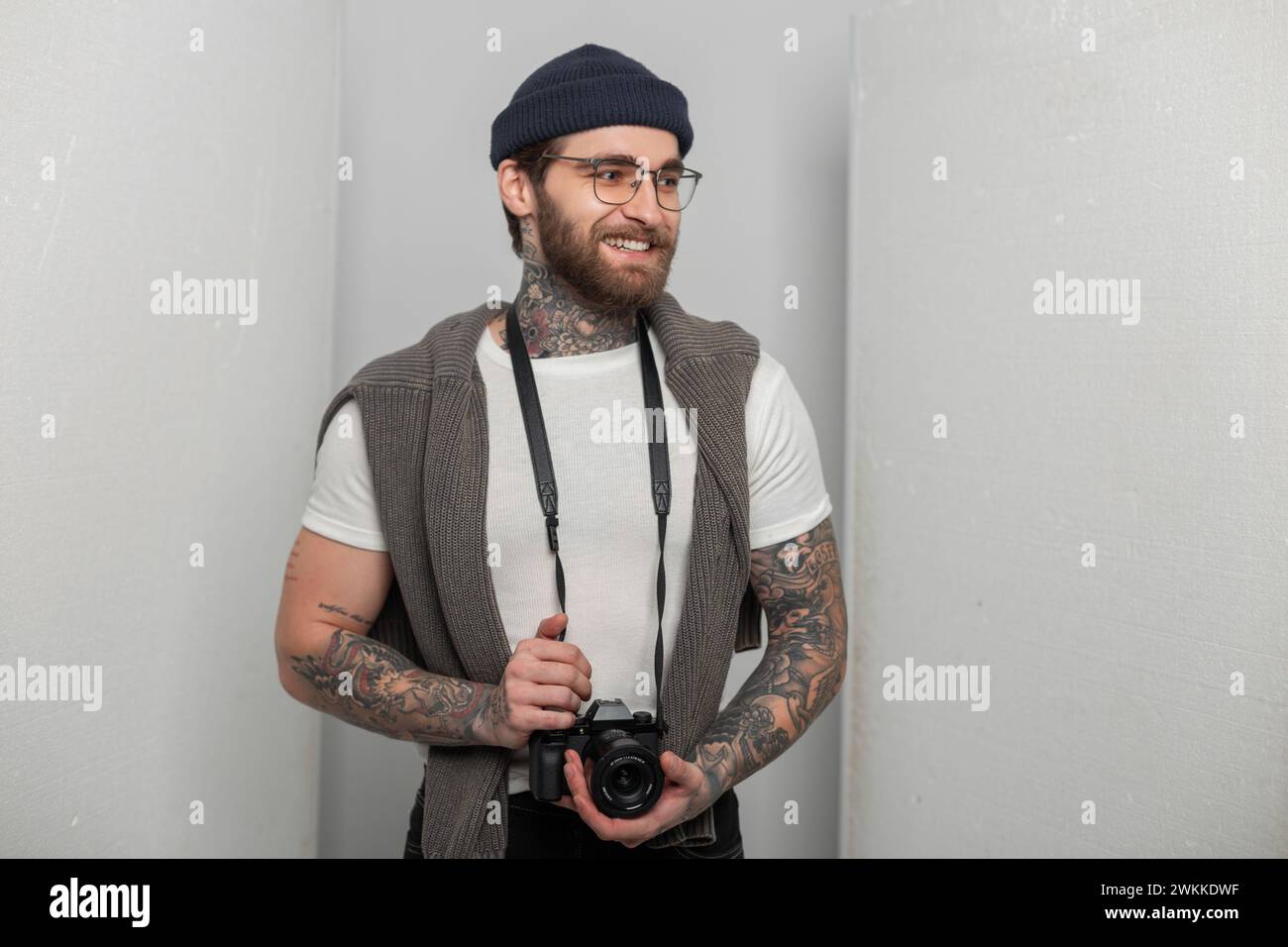 Happy handsome professional photographer man with smile with tattoo ...