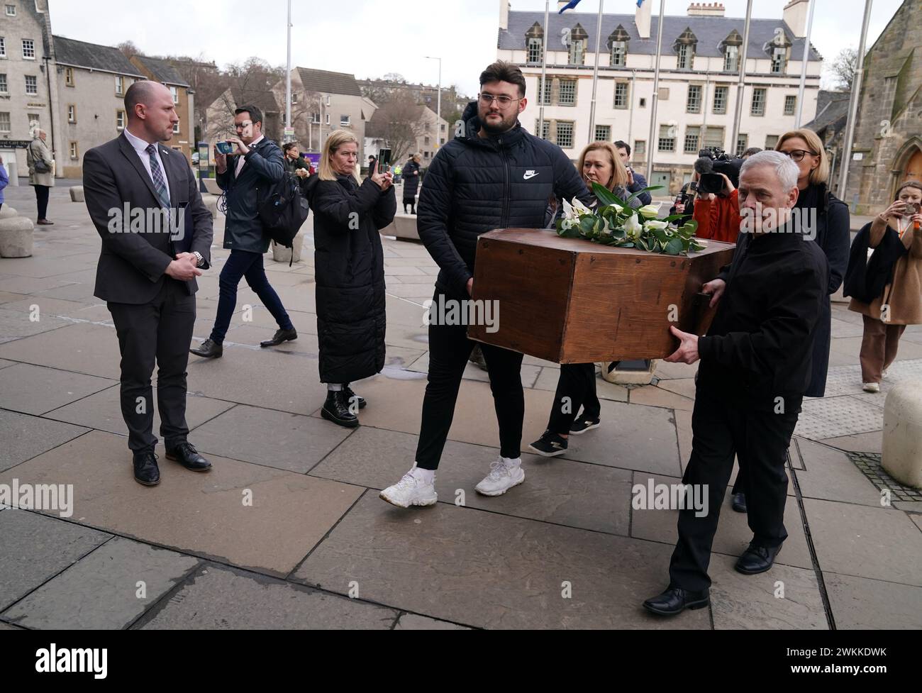 Scottish Health Secretary Neil Gray watches campaigners take part in a ...