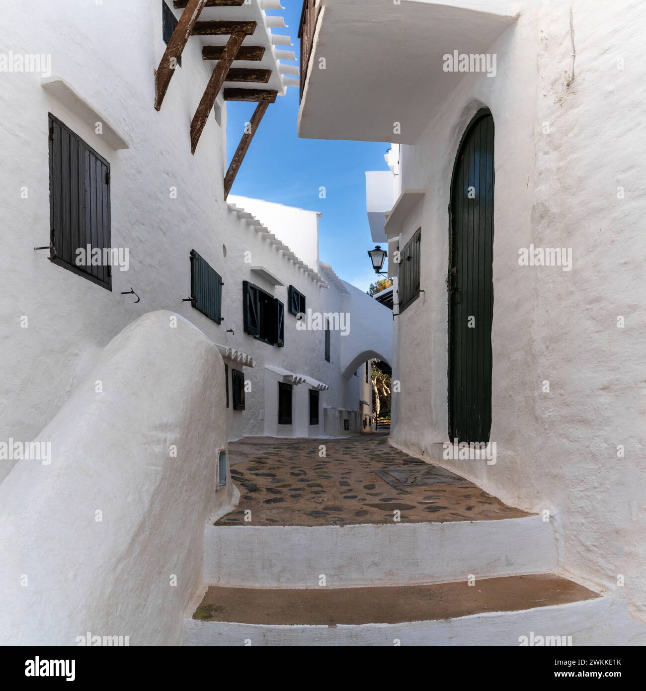 Binibeca Vell, Spain - 24 January, 2024: narrow alley leading through a ...