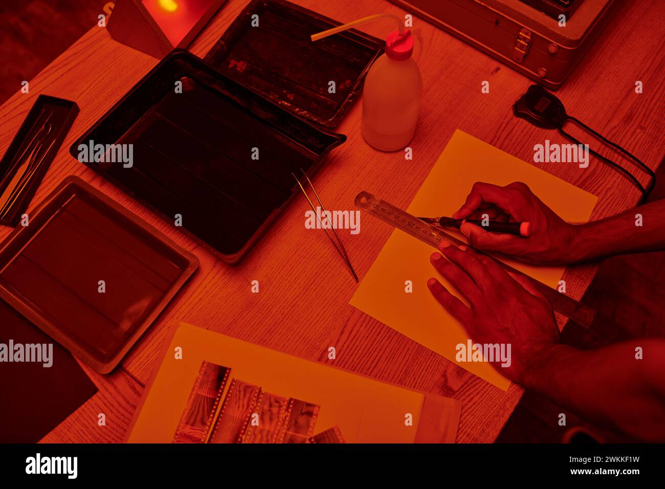 top view of photographer taking precise measurements for photo paper ...