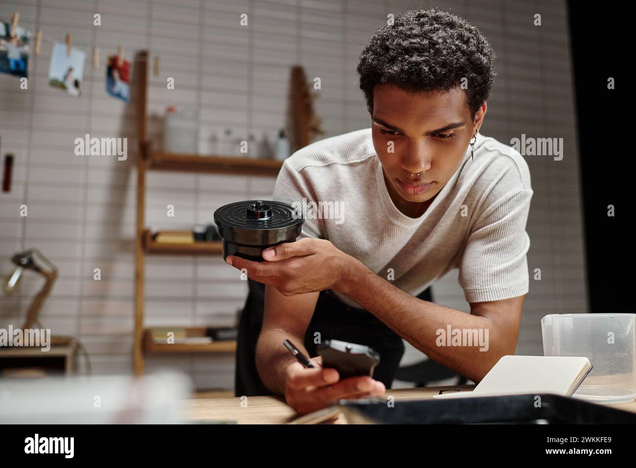 analog film development, dark skinned man meticulously times the ...