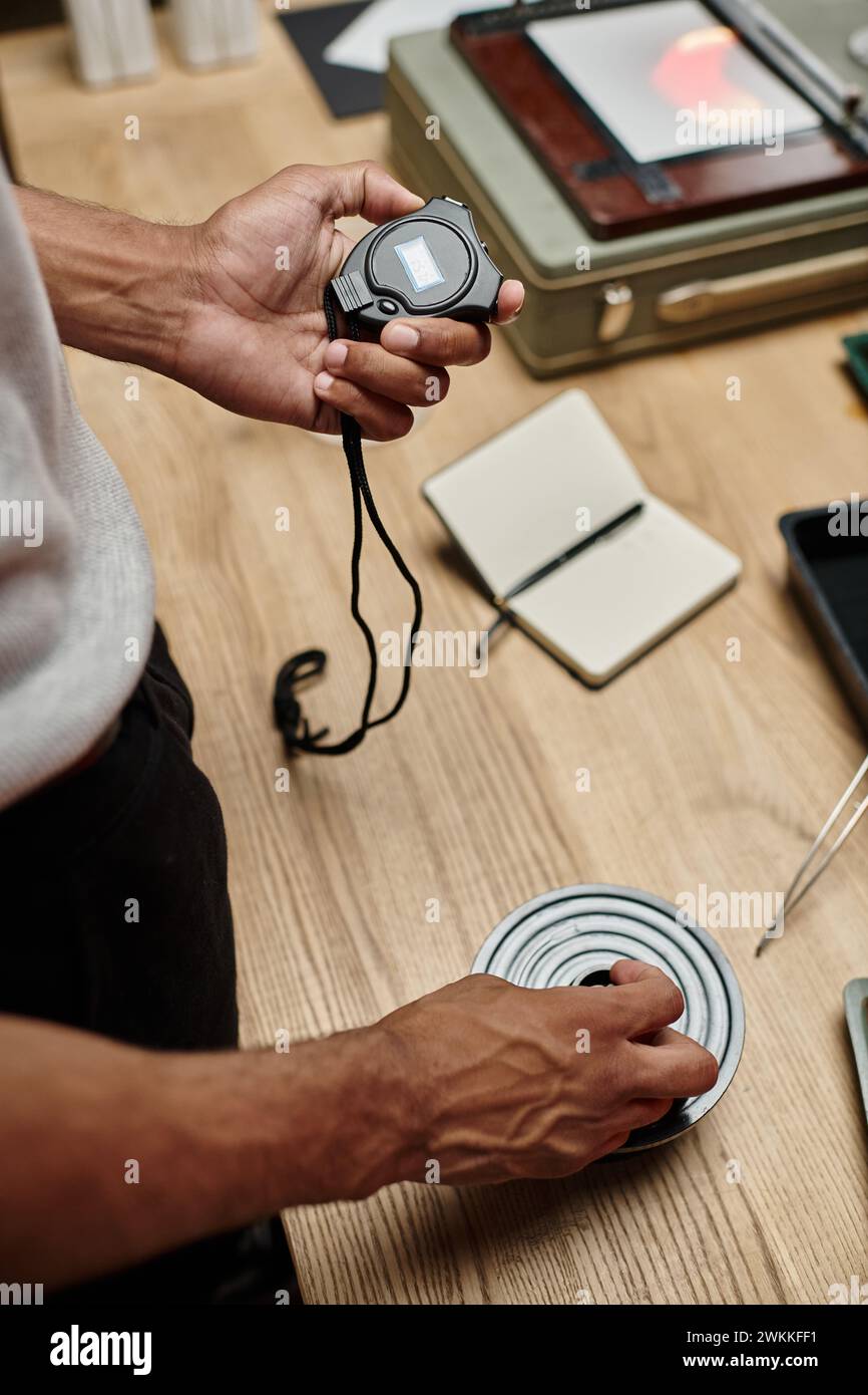 top view of african american photographer using darkroom timer, film ...