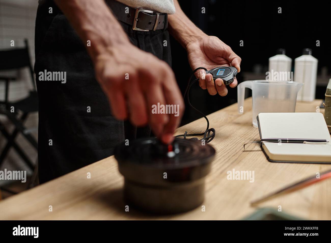 cropped view of african american photographer using darkroom timer ...