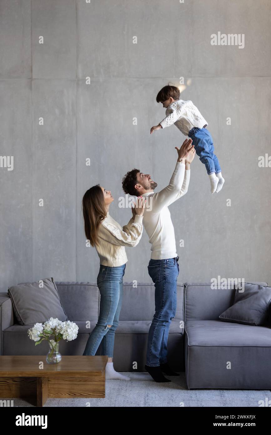 Wellness, relax and father lifting child on sofa for bonding, fun and ...