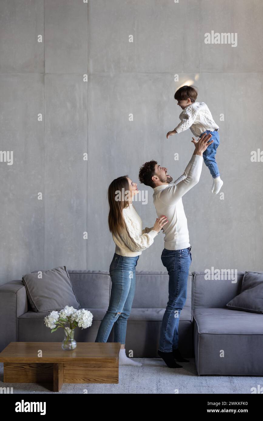 Wellness, relax and father lifting child on sofa for bonding, fun and ...