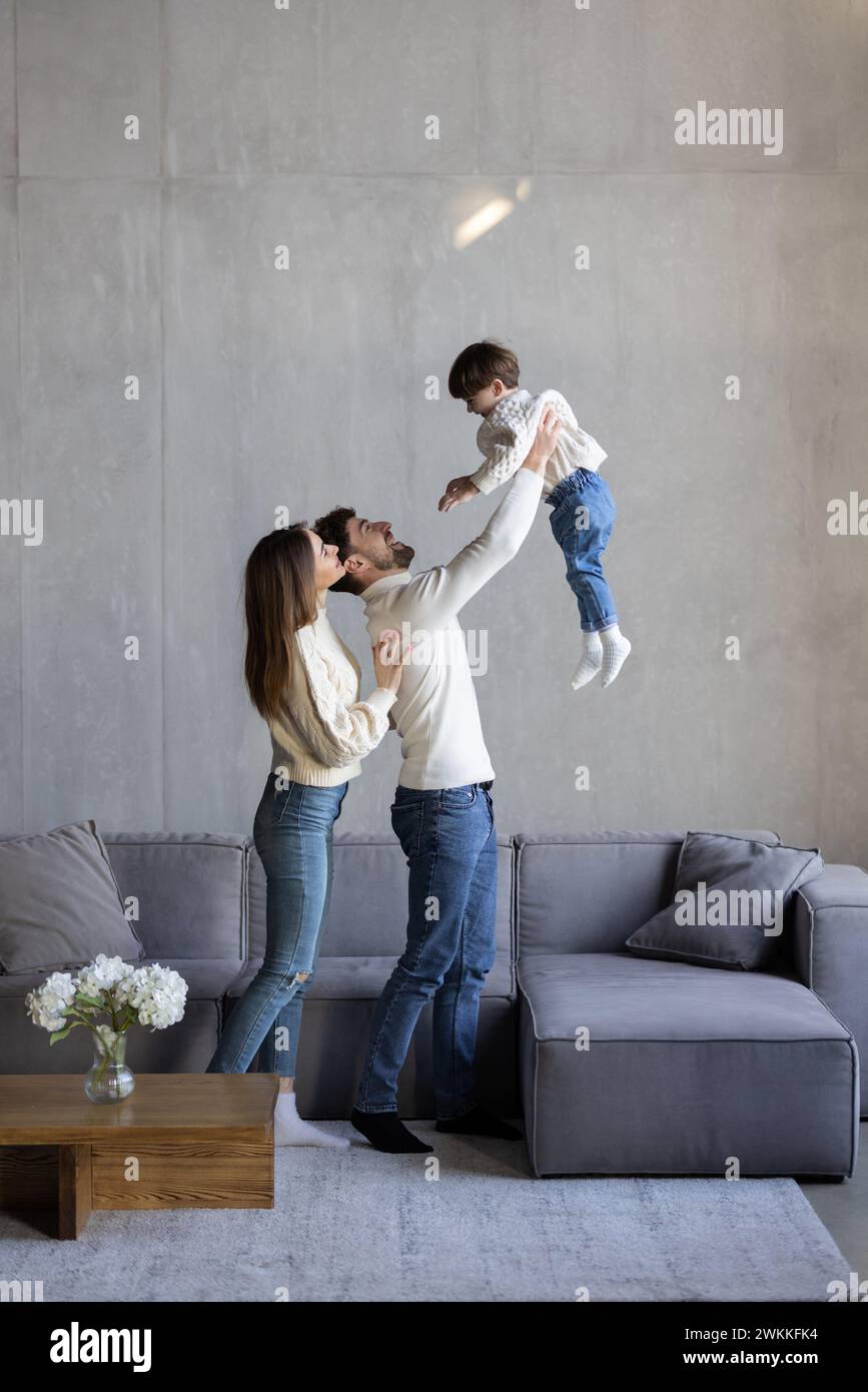 Wellness, relax and father lifting child on sofa for bonding, fun and ...