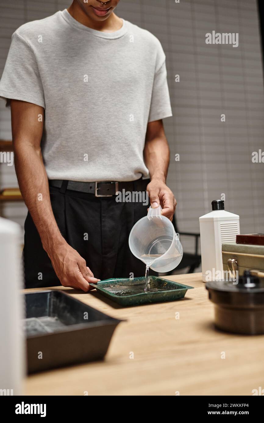process of film development, cropped african american man pouring ...