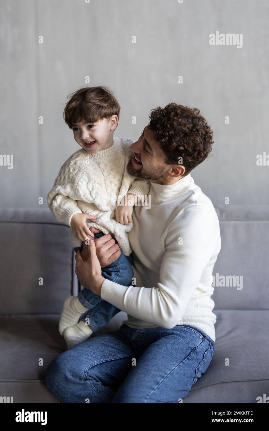 Loving young father and cute little preschooler son hug cuddle enjoying ...