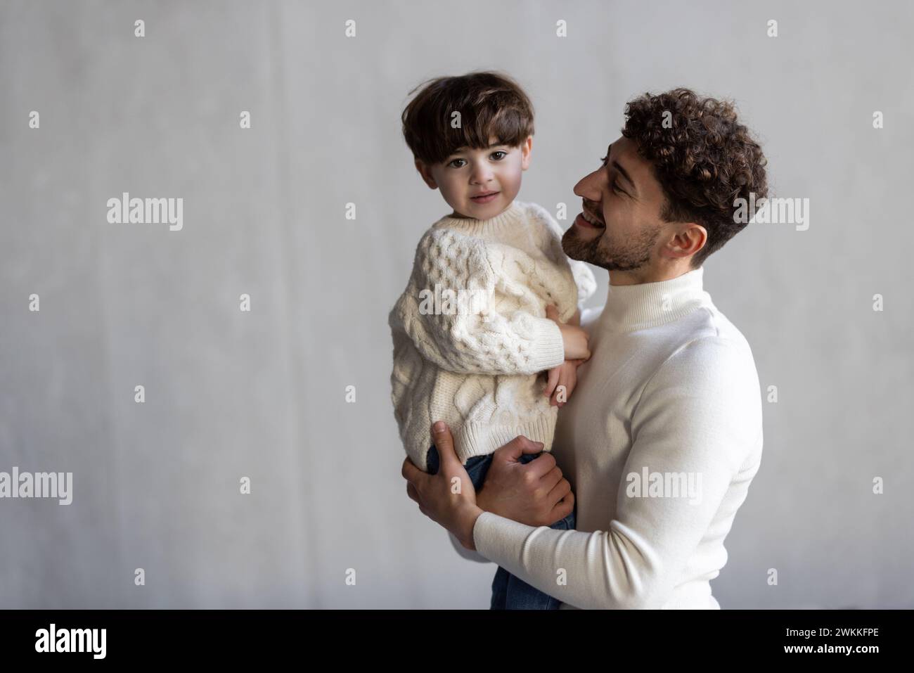 Loving young father and cute little preschooler son hug cuddle enjoying ...