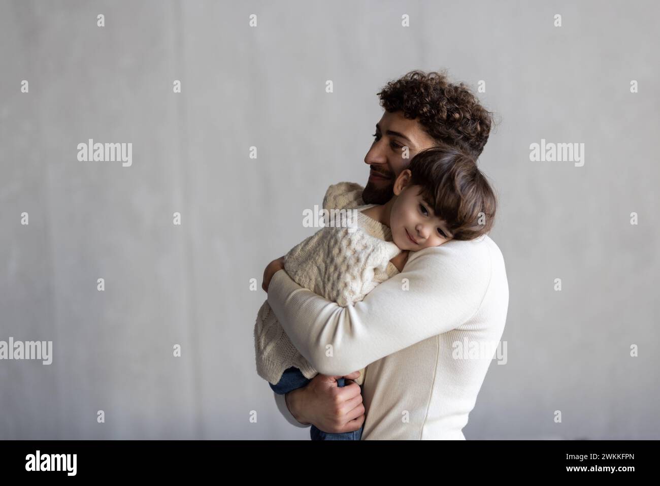 Loving young father and cute little preschooler son hug cuddle enjoying ...