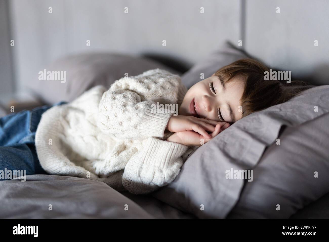 Kid on sleeping bed, happy bedtime in white bedroom Stock Photo - Alamy